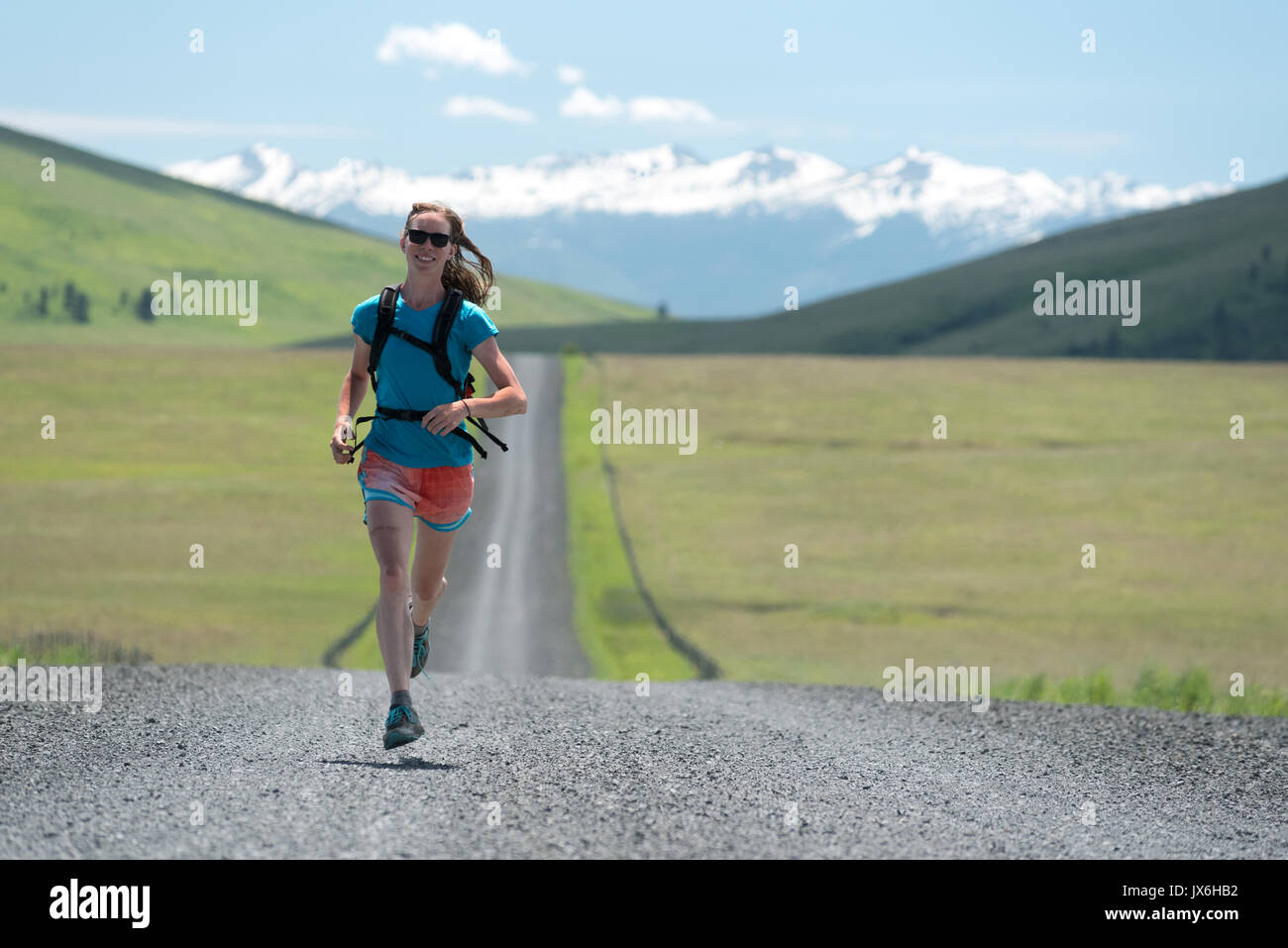 Woman running on a gravel road on the Zumwalt Prairie in Northeast ...
