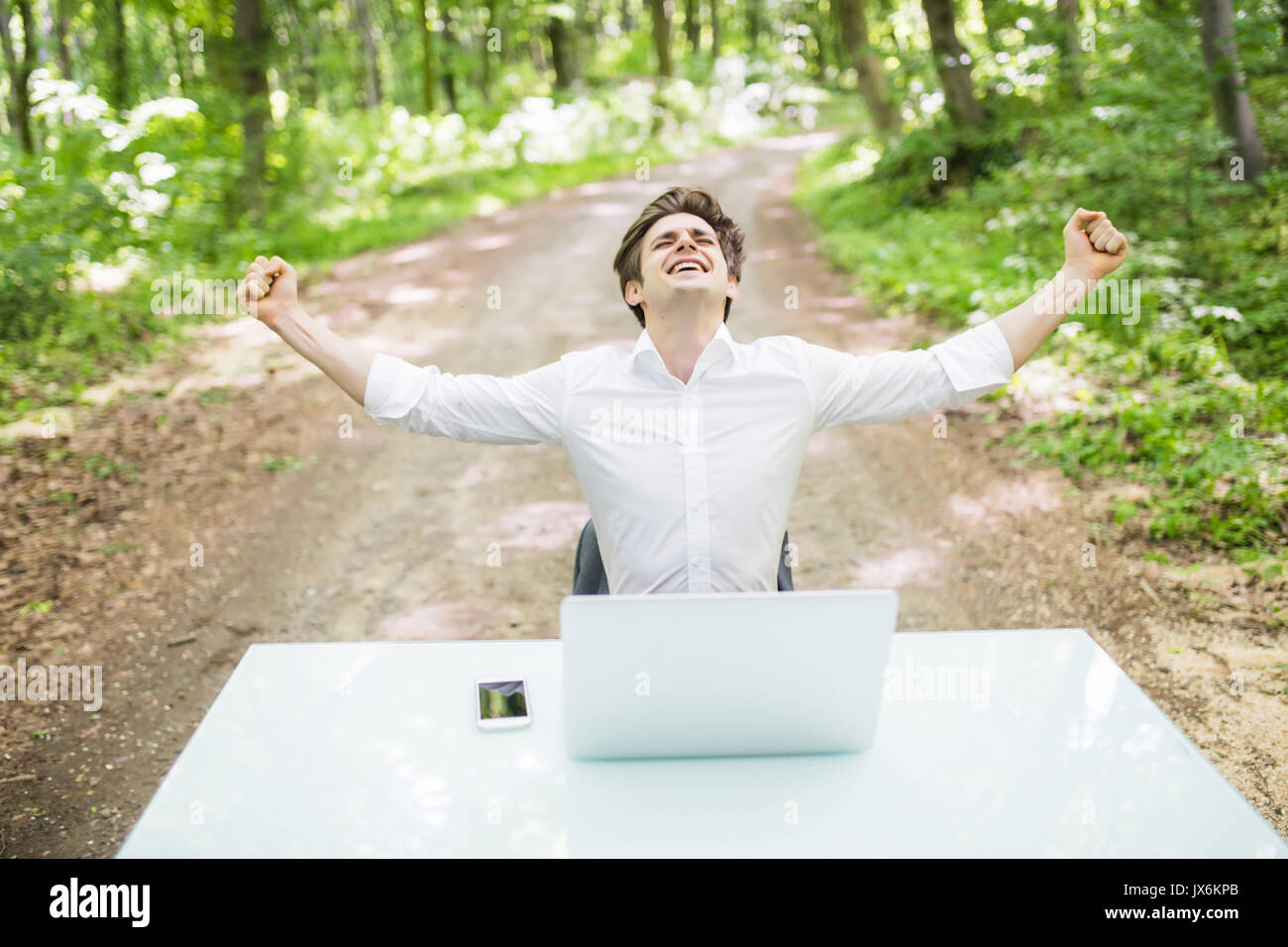 Happy business man with raised hands up celebrate great job or good ...