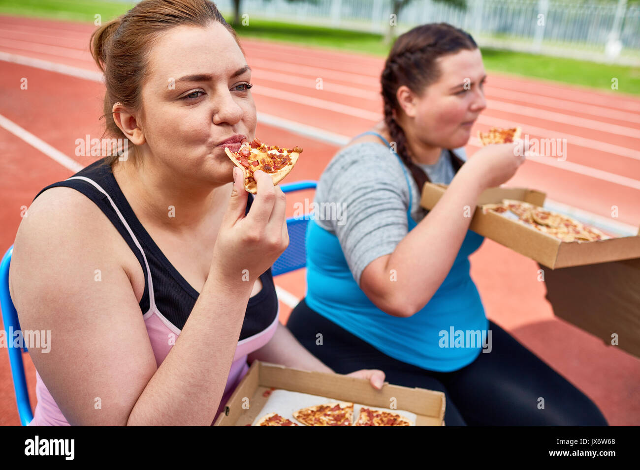 Young woman eating tasty snack hi-res stock photography and images - Alamy