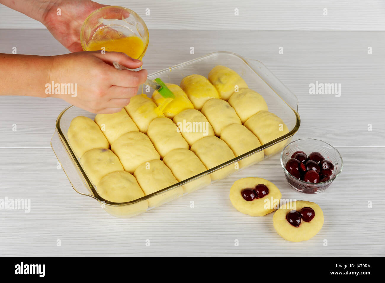Rolls from the dough on a dripping pan before bake Homemade buns before ...