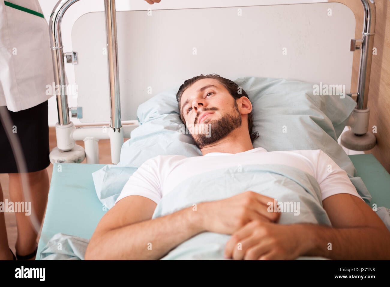 Sick Patient in hospital room next to nurses Stock Photo - Alamy