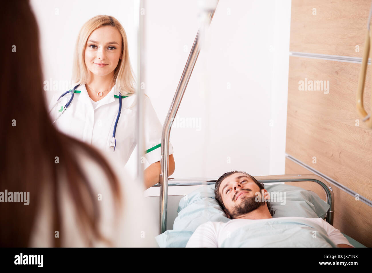 Sick male Patient in hospital room next to nurses Stock Photo - Alamy