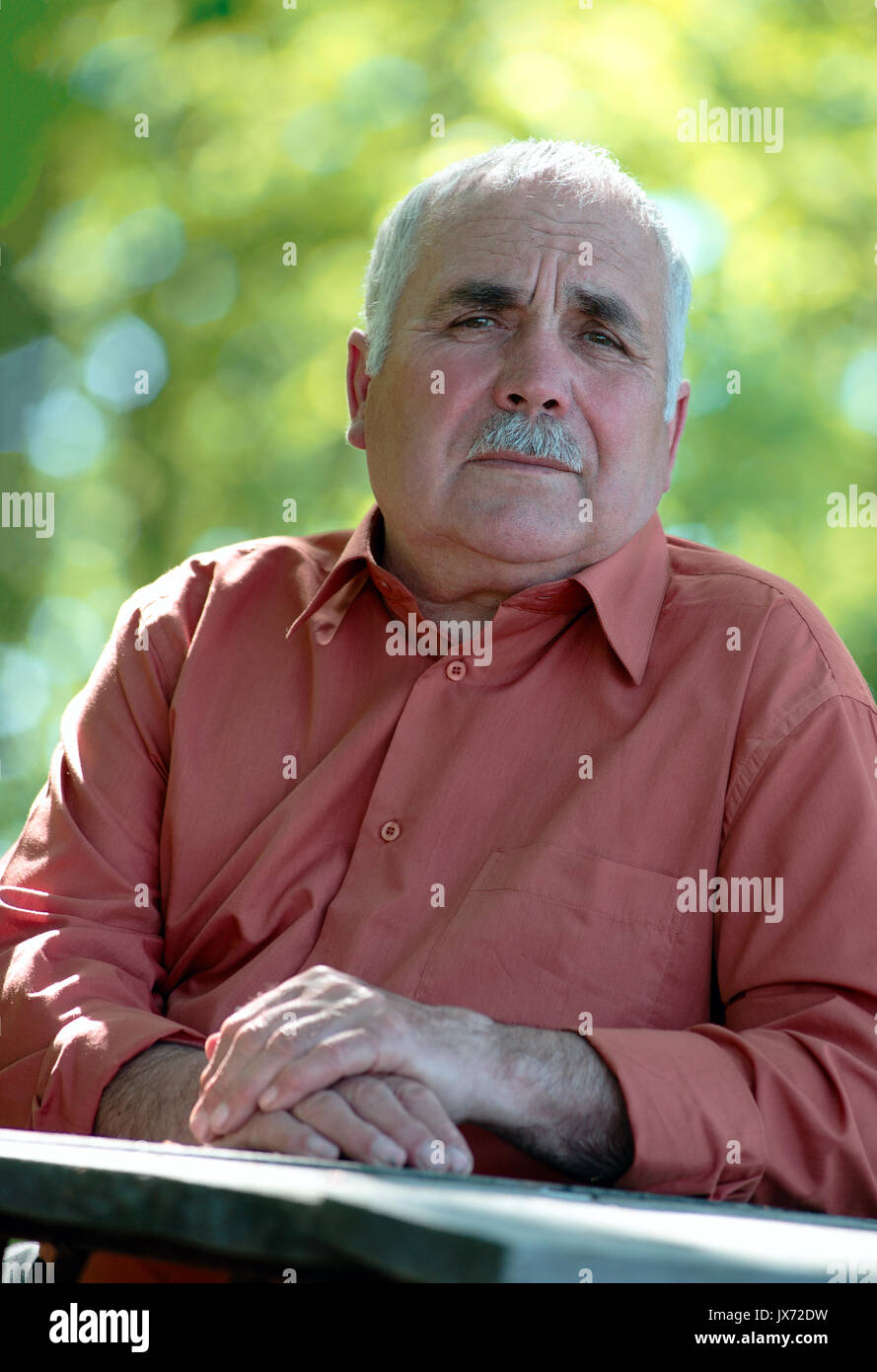Portrait of a wistful sad senior man with grey hair and a moustache ...