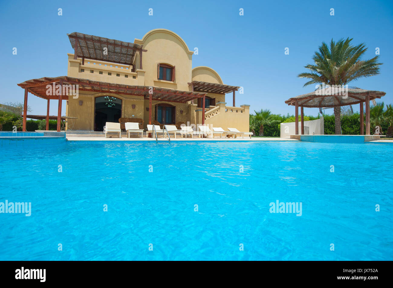 Luxury villa show home in tropical summer holiday resort with swimming ...