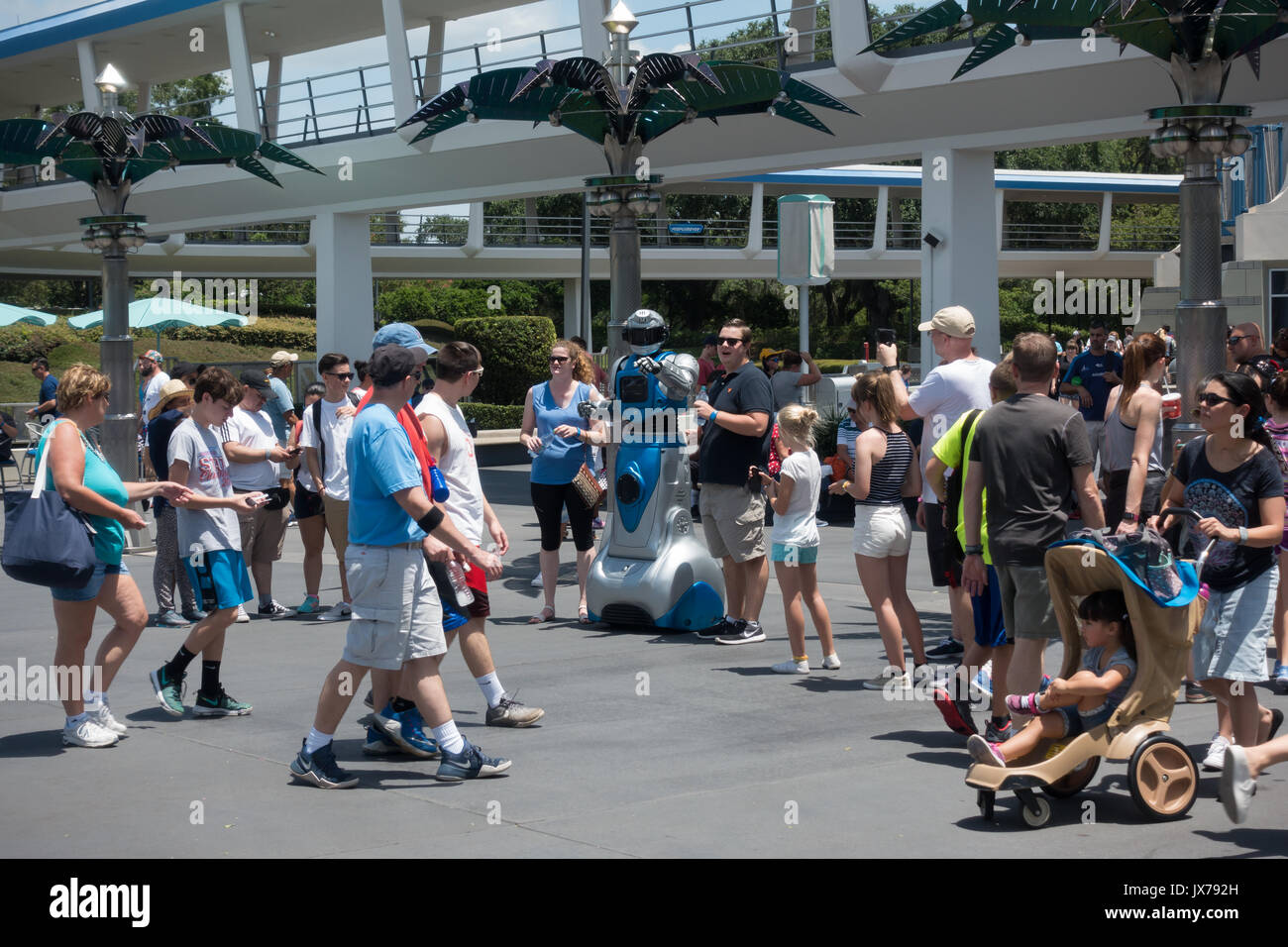 Guests interacting with iCan robot in Tomorrowland, Magic Kingdom ...