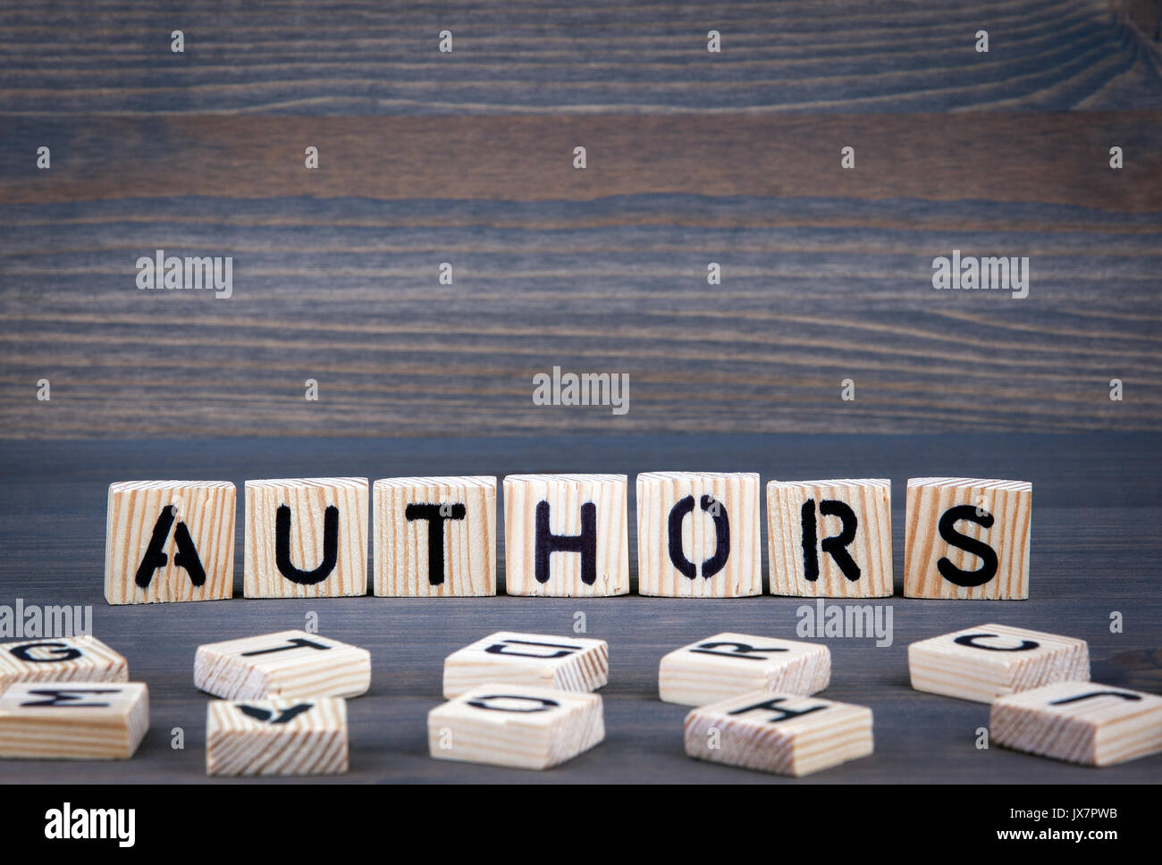 Authors word written on wood block. Dark wood background with texture ...