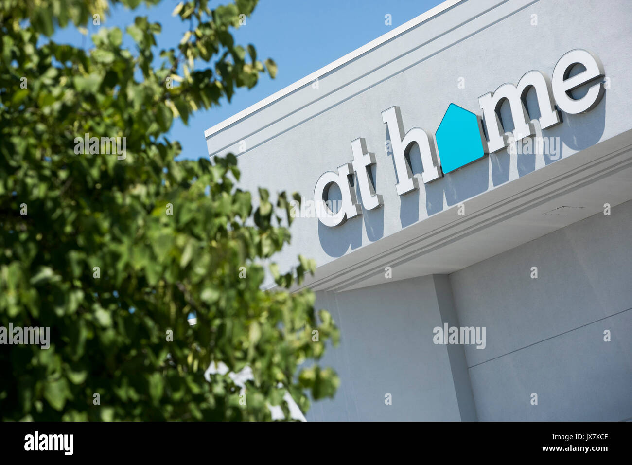 A logo sign outside of a At Home retail store in York, Pennsylvania on ...
