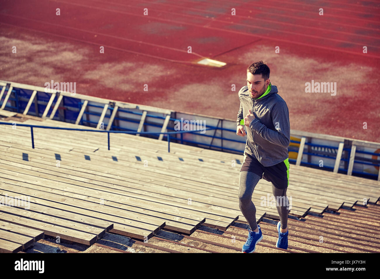 young man running upstairs on stadium Stock Photo - Alamy