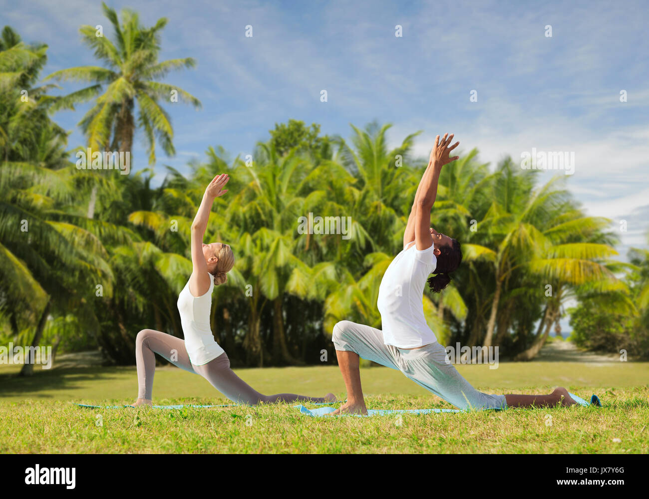 couple making yoga in low lunge pose outdoors Stock Photo - Alamy