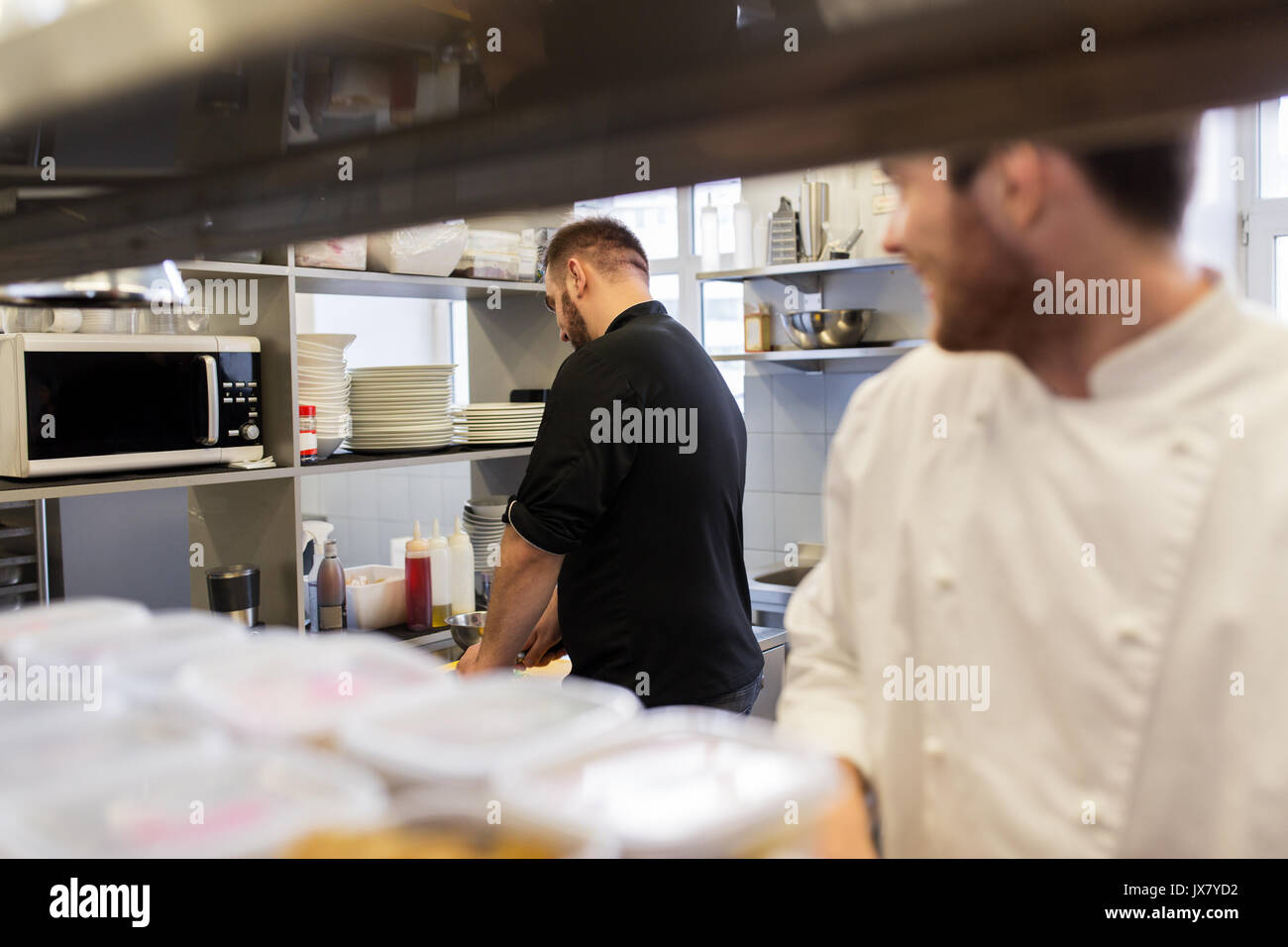 chef and cook cooking food at restaurant kitchen Stock Photo - Alamy