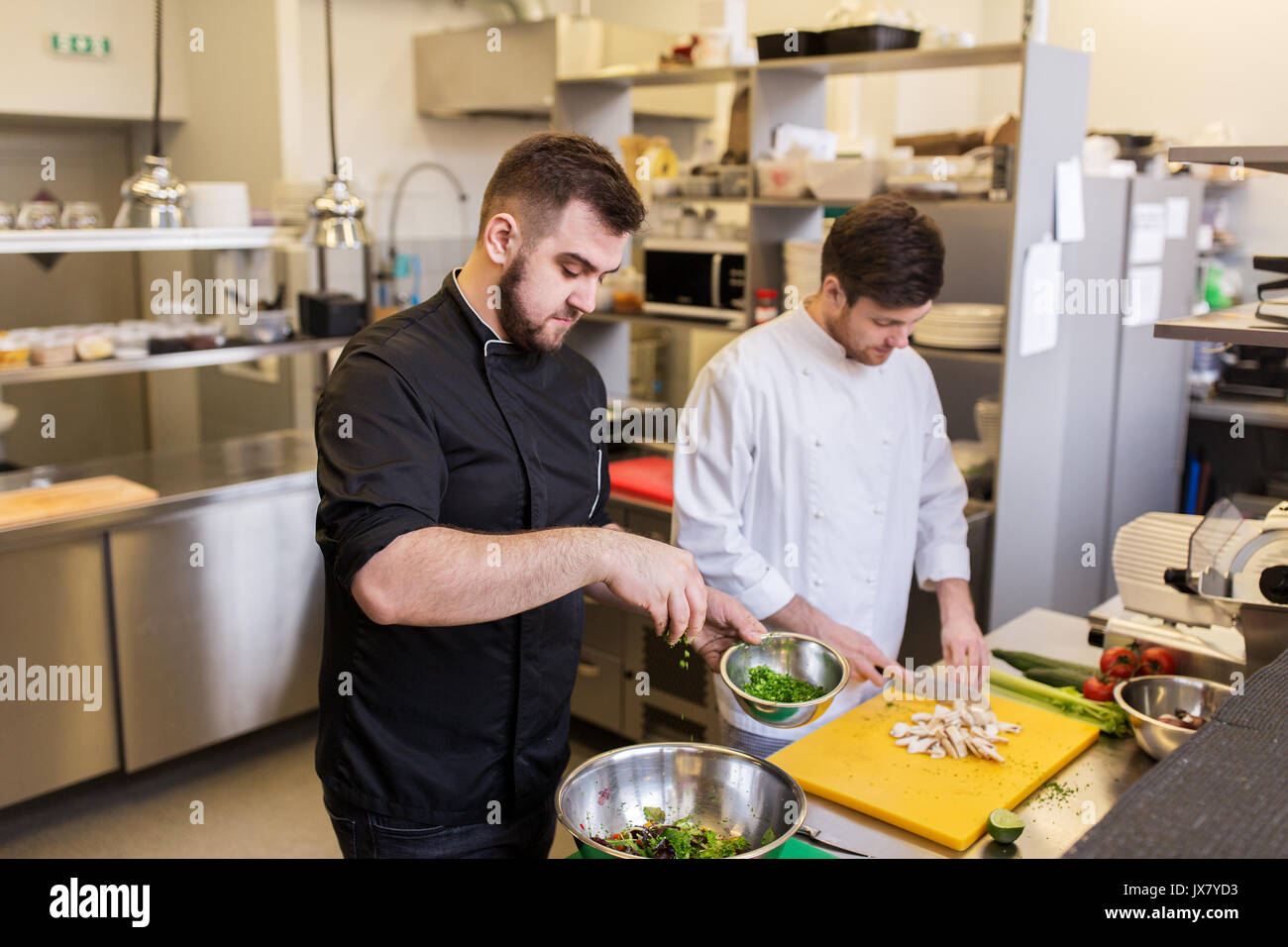 chef and cook cooking food at restaurant kitchen Stock Photo - Alamy