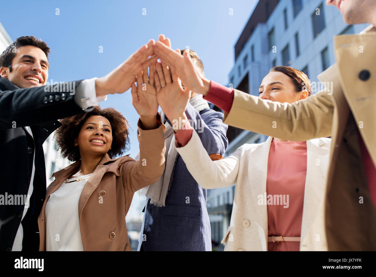 group of happy people making high five in city Stock Photo - Alamy
