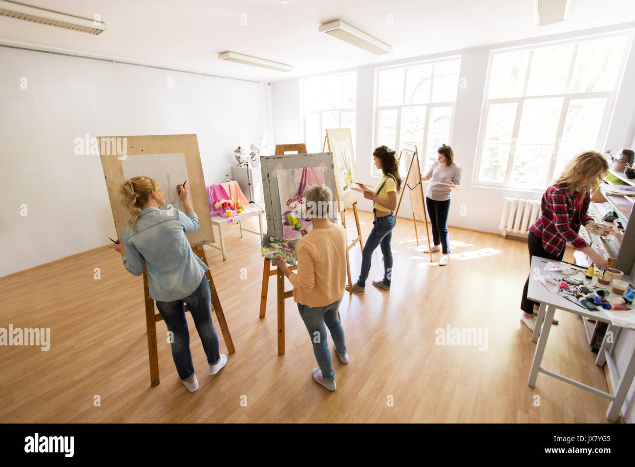 woman artists with brushes painting at art school Stock Photo - Alamy