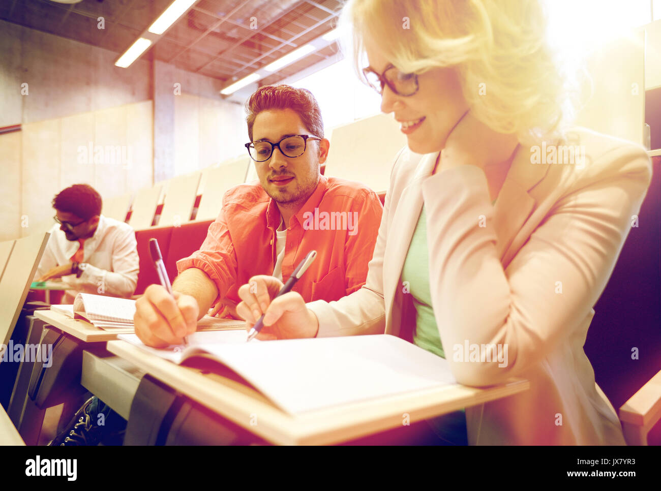 group of students with notebooks at lecture hall Stock Photo - Alamy