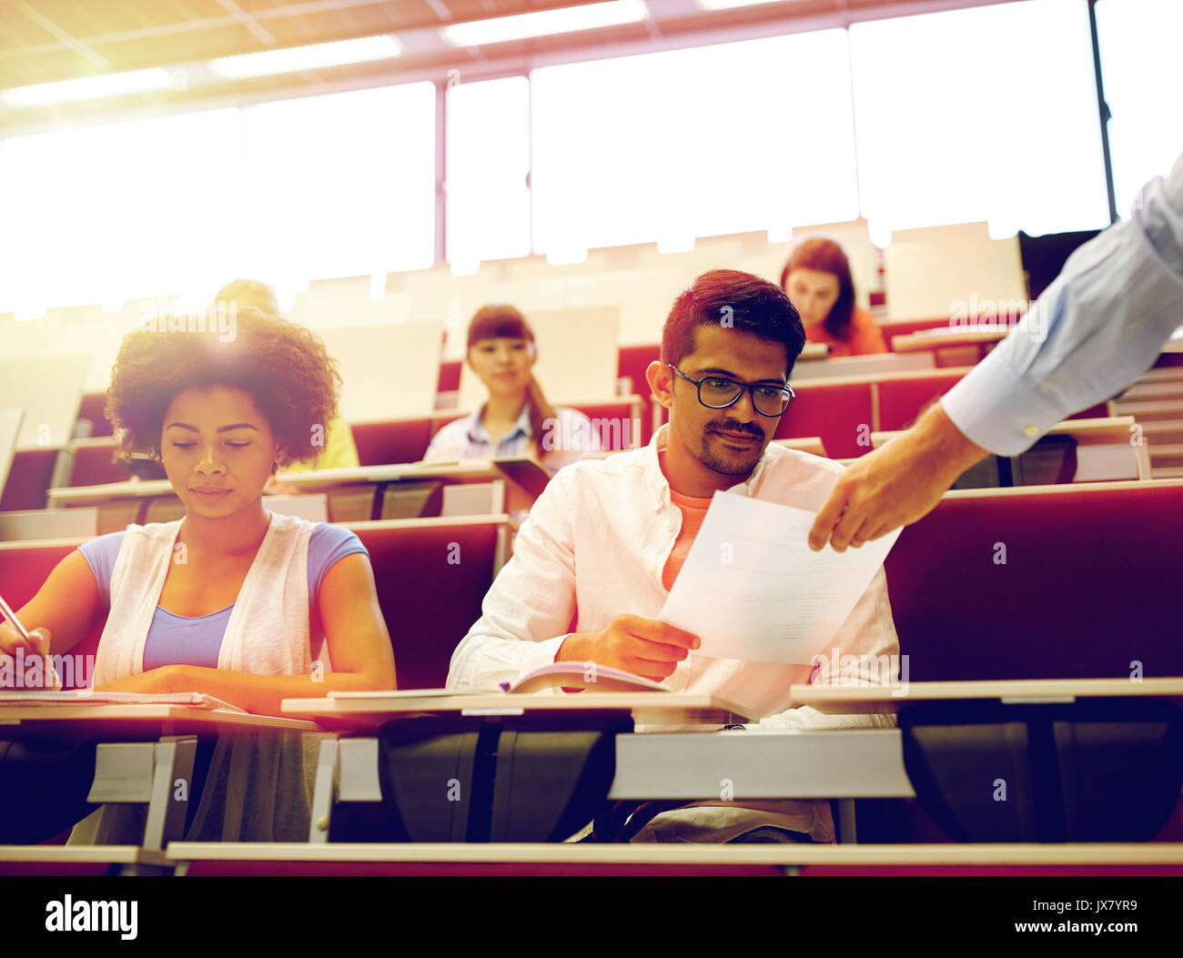 teacher giving tests to students at lecture Stock Photo - Alamy