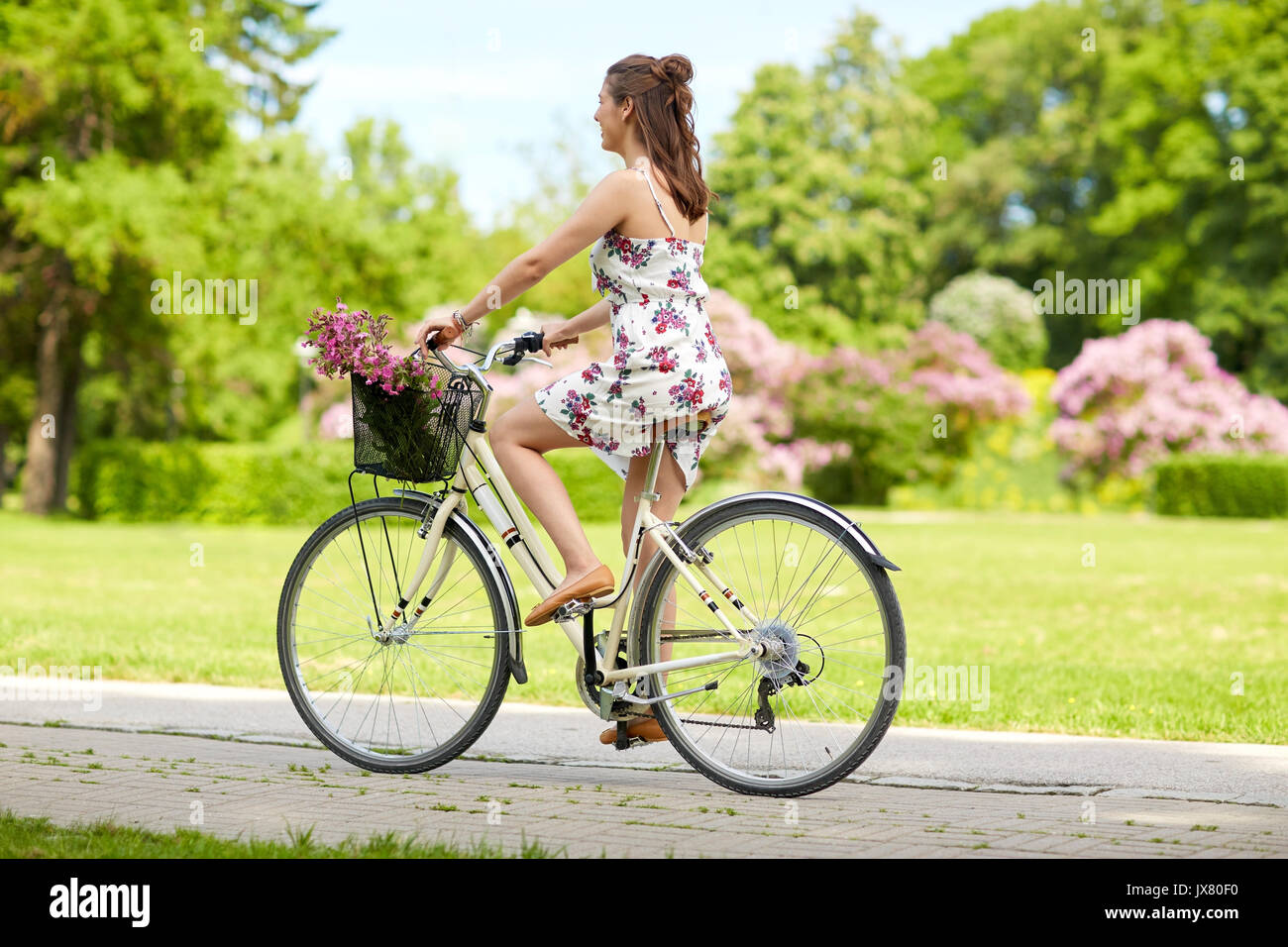 happy woman riding fixie bicycle in summer park Stock Photo - Alamy
