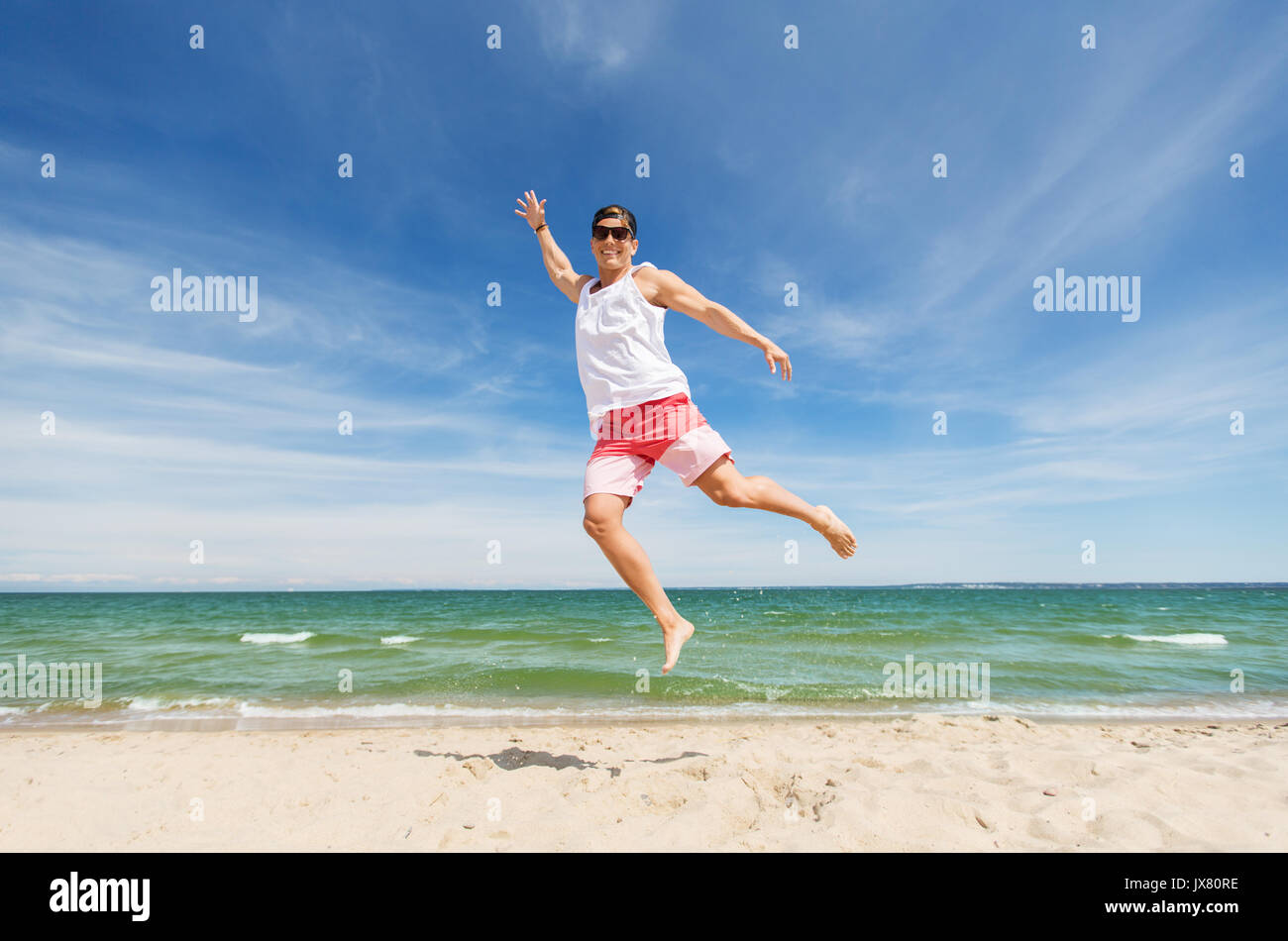 Man jumping on the beach hi-res stock photography and images - Alamy