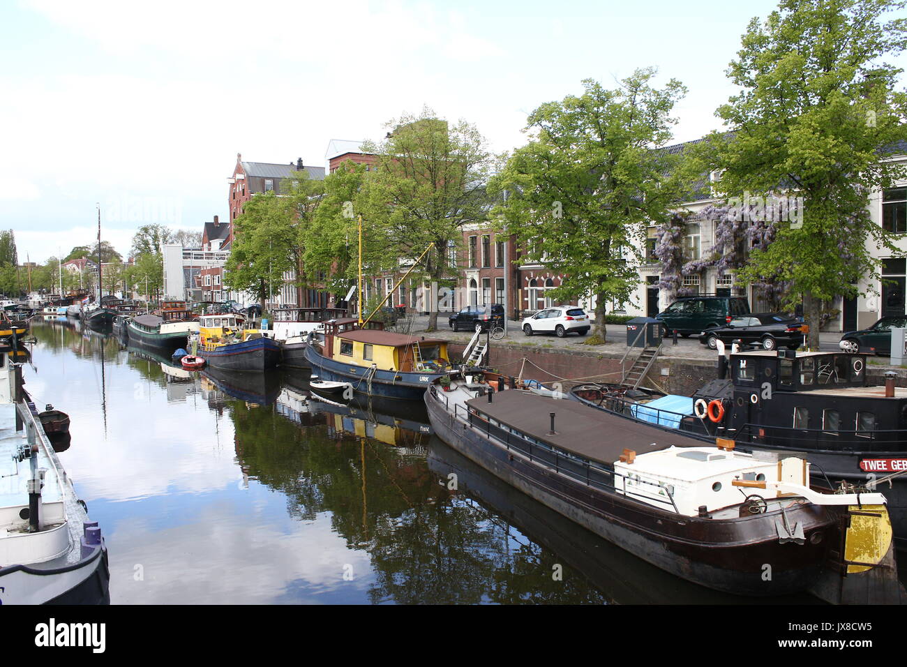 Warehouses and old sailing ships moored along Noorderhaven canal ...