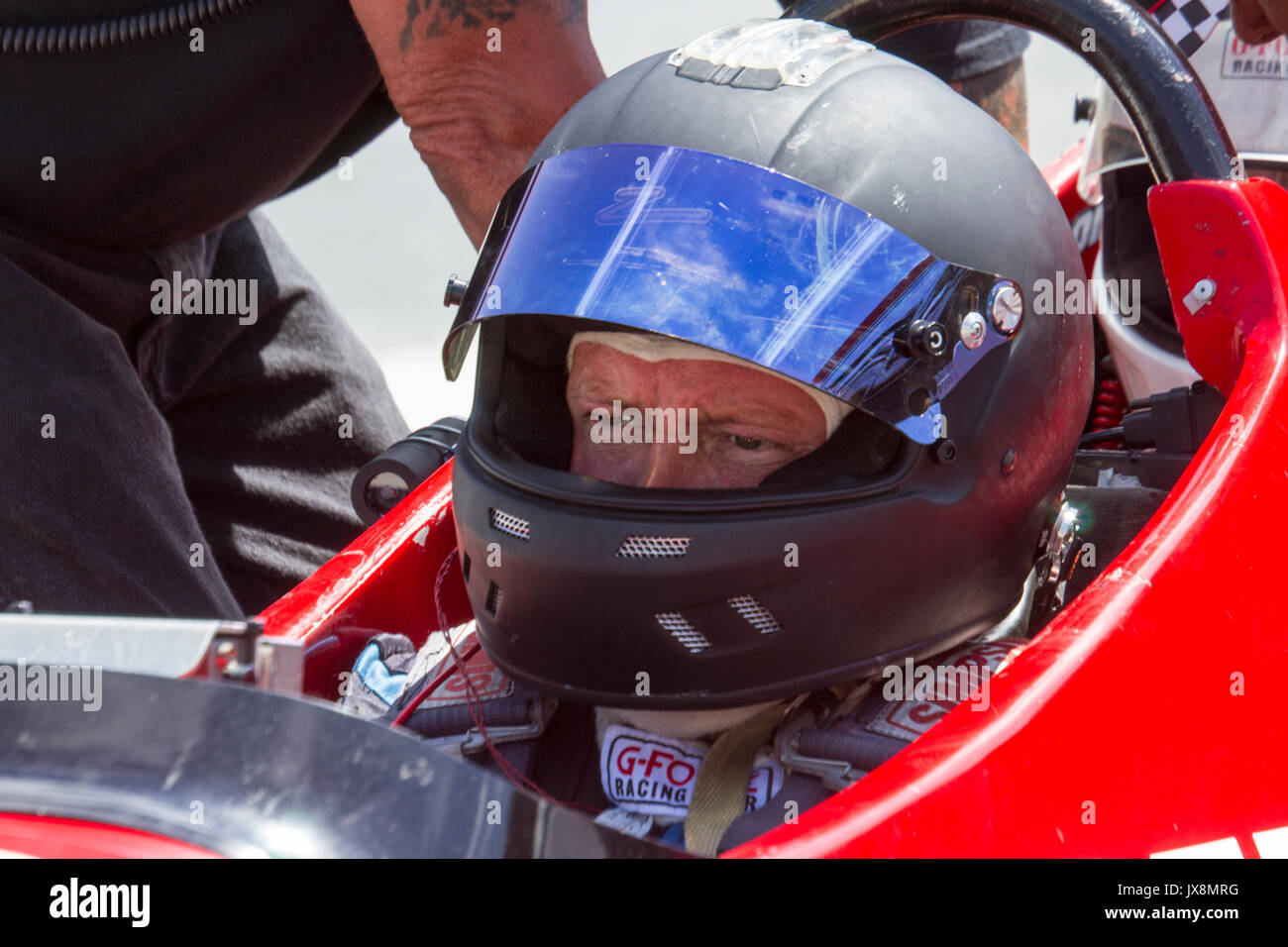 IRL race car with driver on pit row at Dover Motor Speedway with empty ...