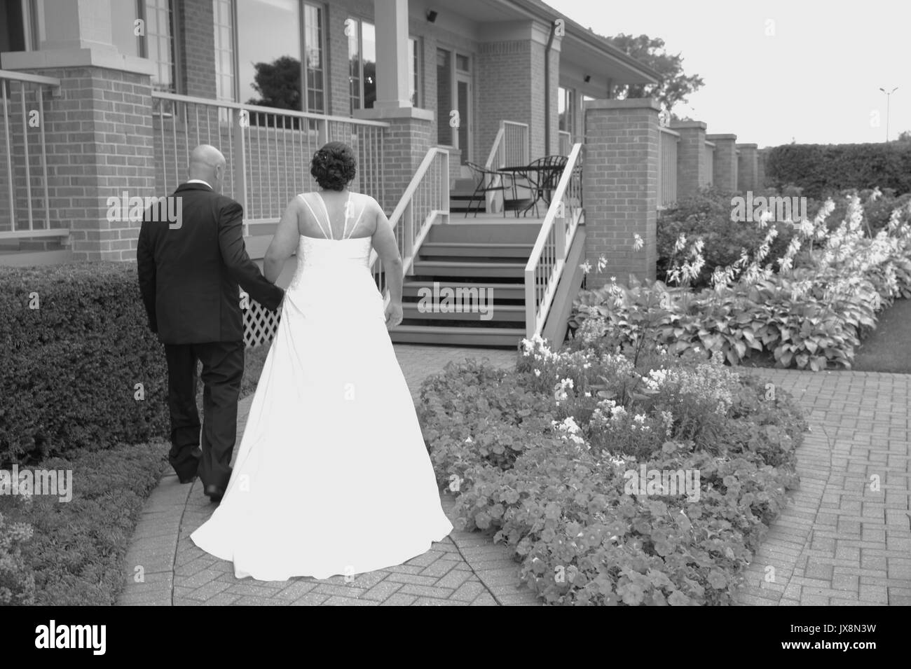 Bride walking up steps after ceremony Stock Photo - Alamy