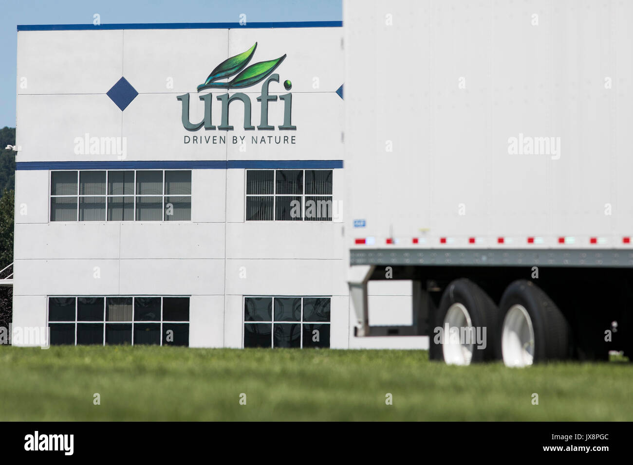 A logo sign outside of a facility occupied by United Natural Foods ...