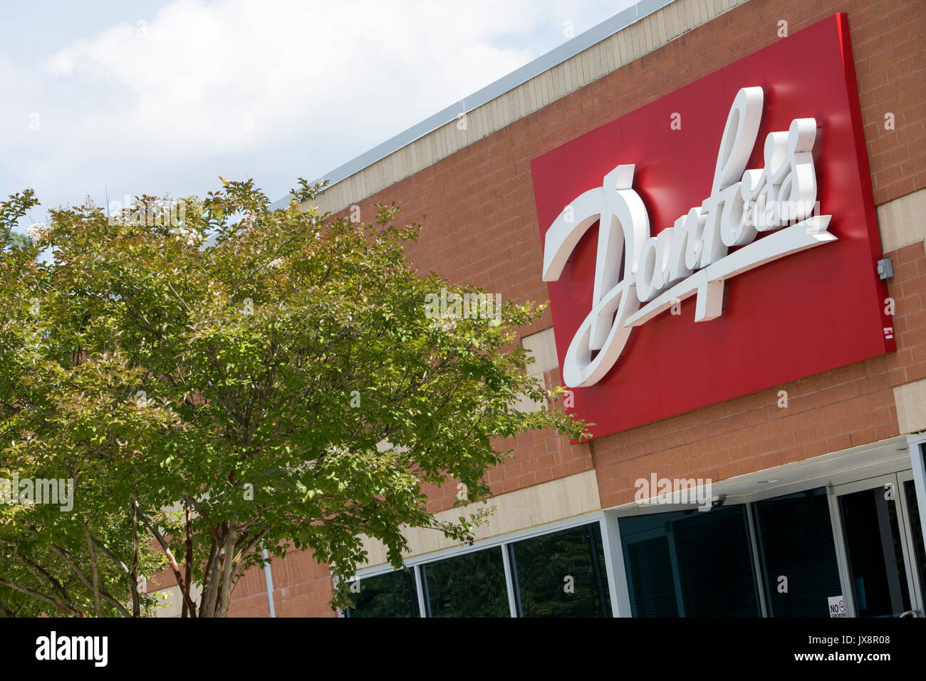 A logo sign outside of a facility occupied by The Danfoss Group in ...