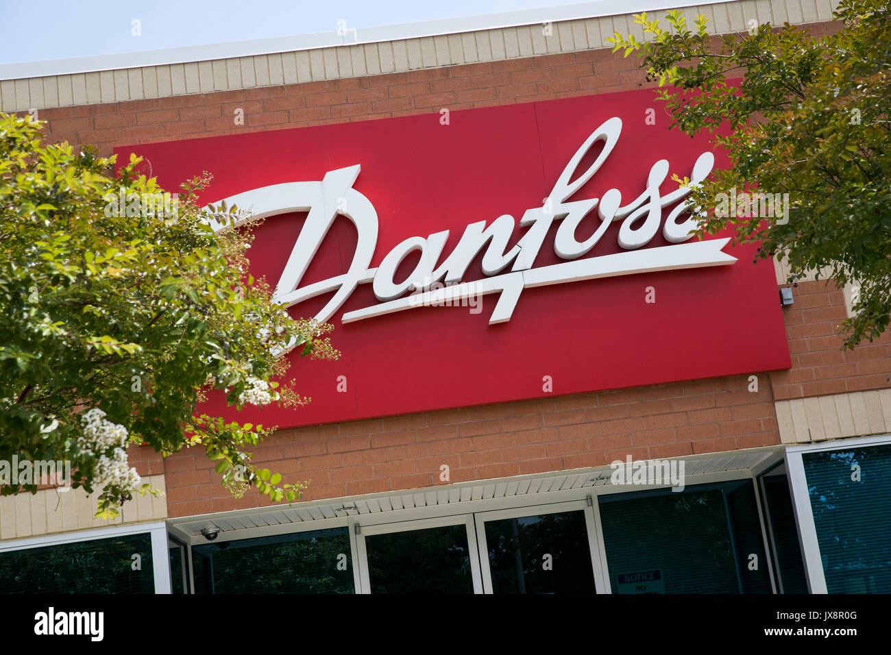 A logo sign outside of a facility occupied by The Danfoss Group in ...