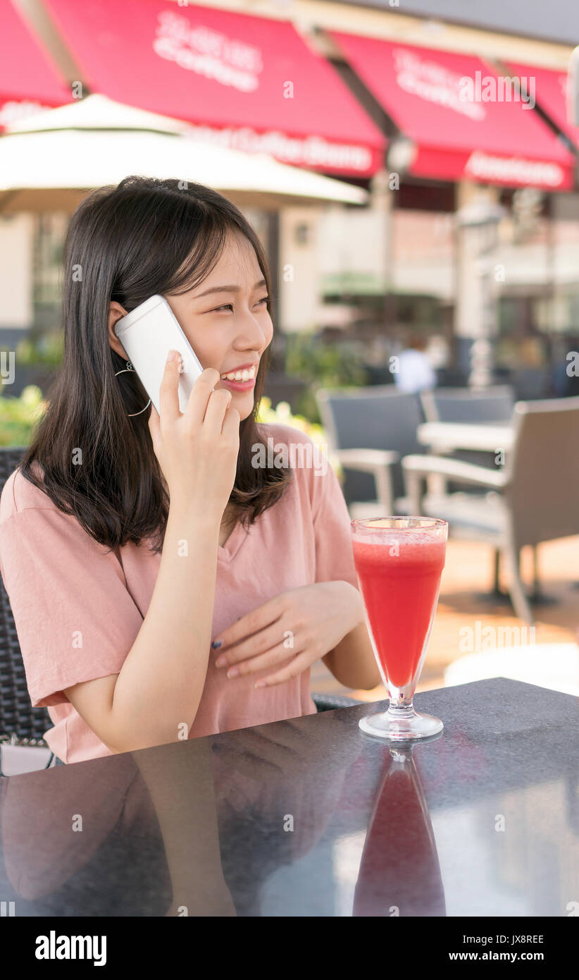 Chinese girl calling in cafe Stock Photo - Alamy