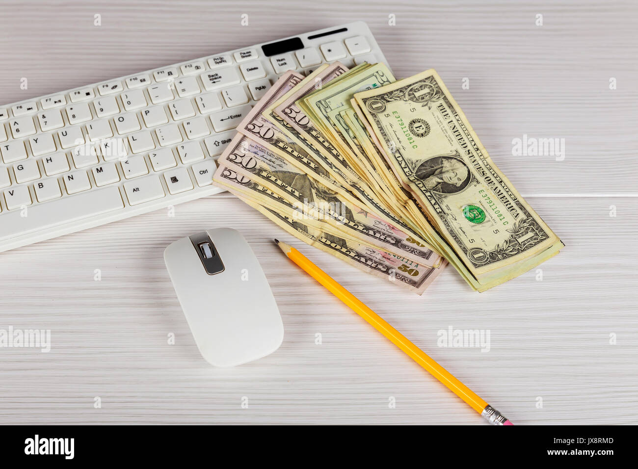 Dollar bill on laptop hi-res stock photography and images - Alamy