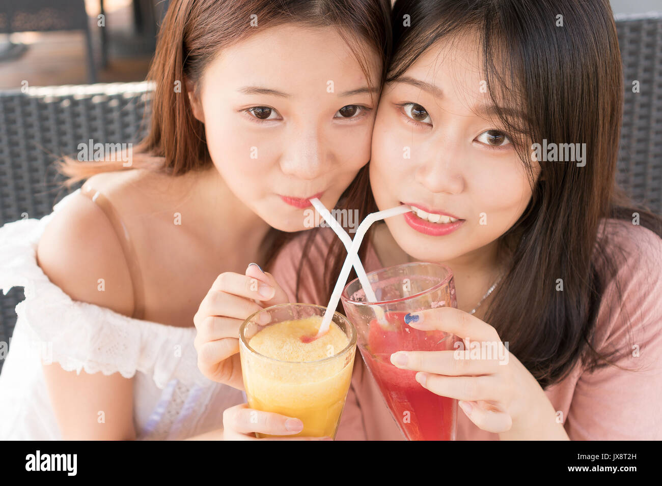 two girls drinking juice Stock Photo - Alamy