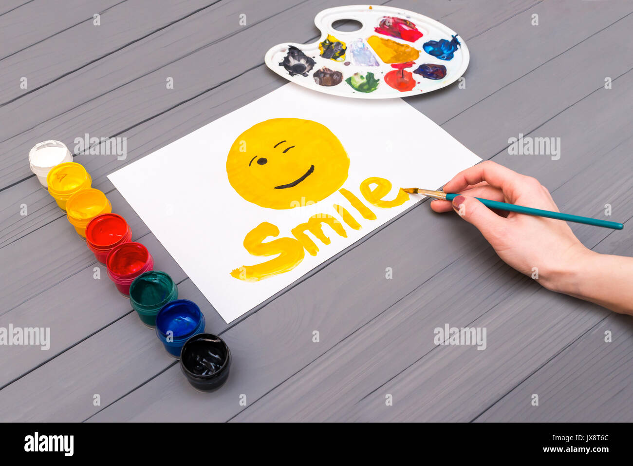 Hand draws smile on sheet Stock Photo - Alamy