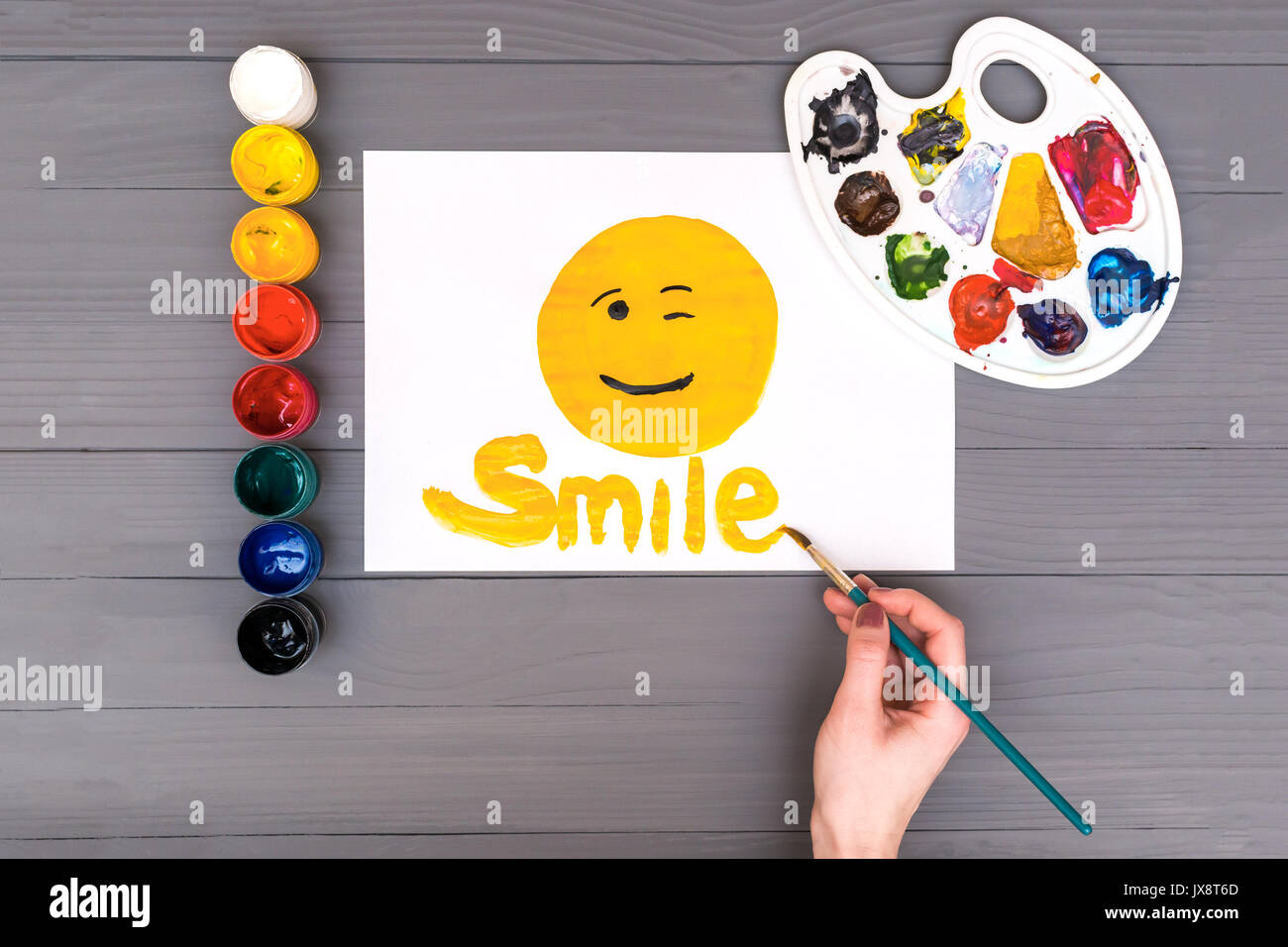 Hand draws smile on sheet Stock Photo - Alamy
