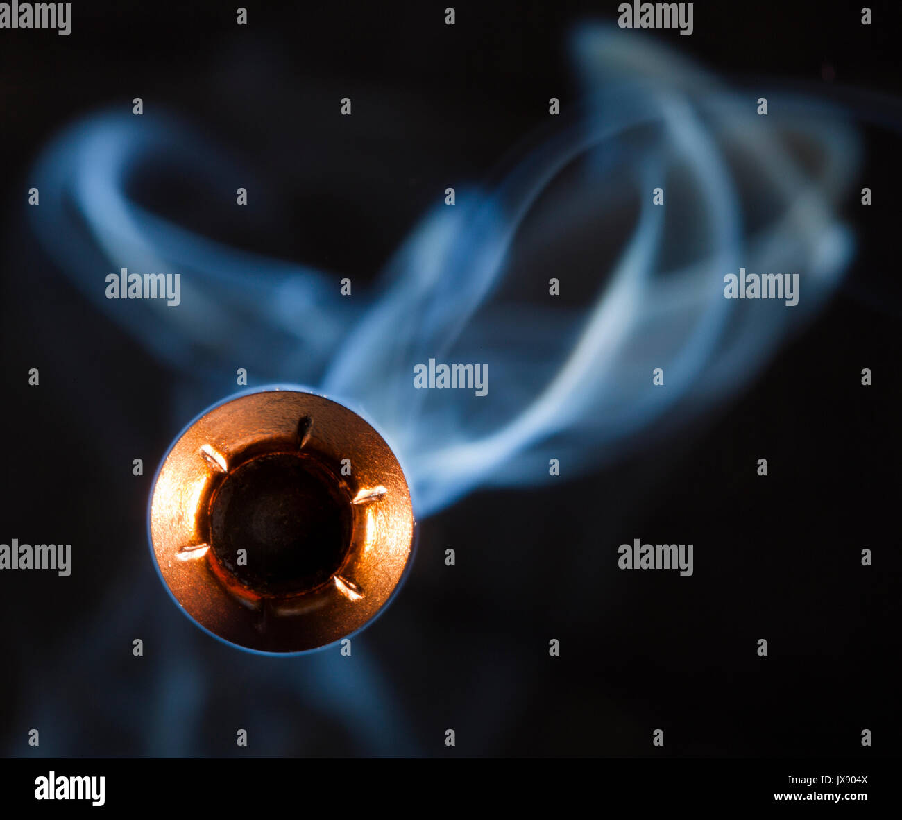 Hollow point bullet coming at the camera with smoke behind Stock Photo ...