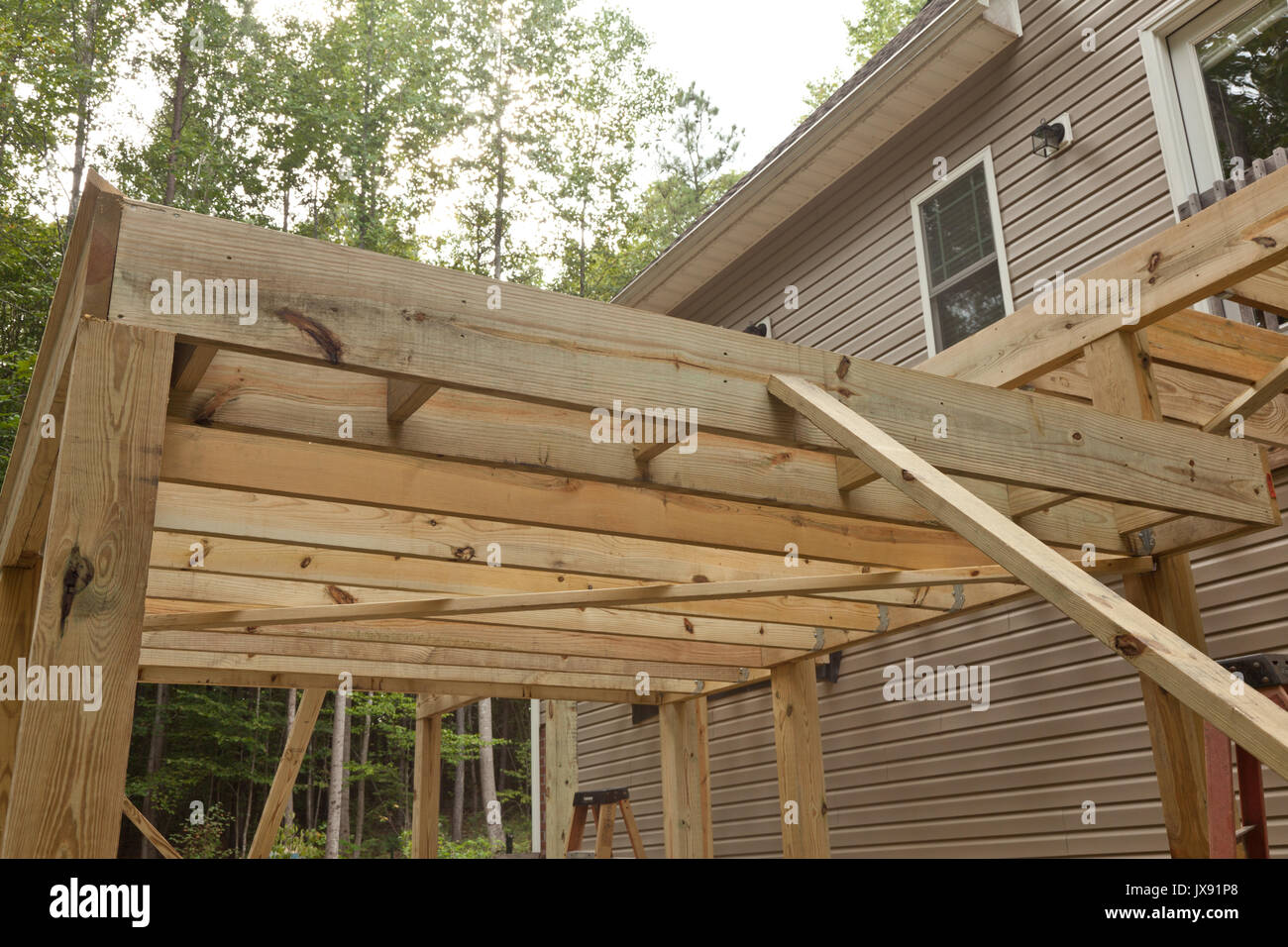 Lumber framing on a new deck with metal support Stock Photo - Alamy