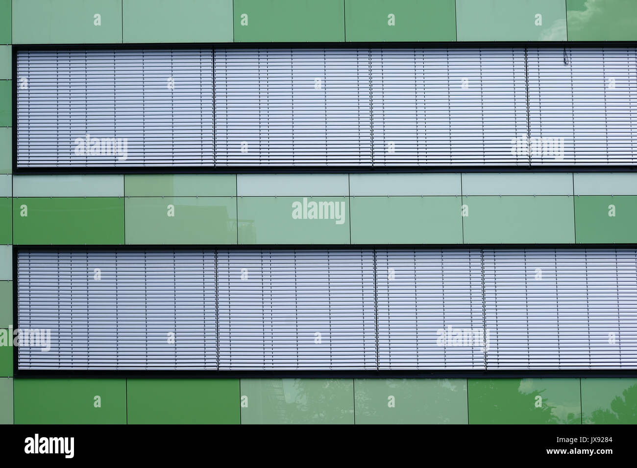 The modern facade of an office building with window rows and metal ...