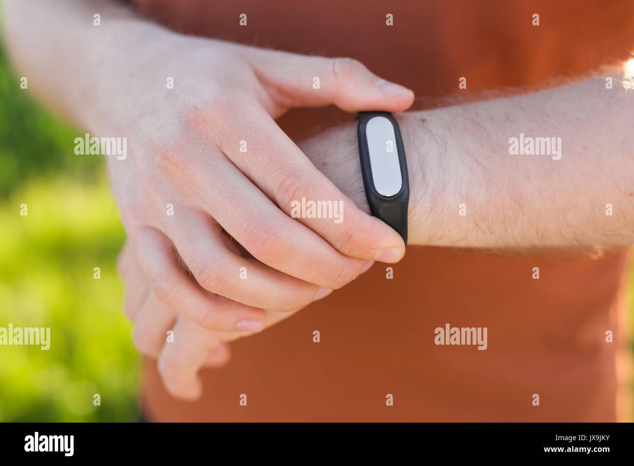 Sportsman checking his pulse on smart watch tracker Stock Photo - Alamy