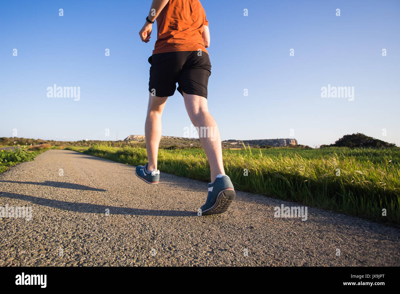 Athletic young man running in the nature. Healthy lifestyle Stock Photo ...
