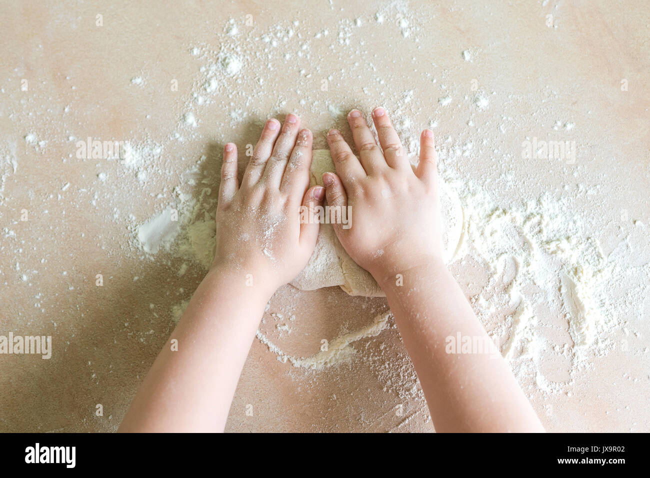Children's hands make dough Stock Photo - Alamy