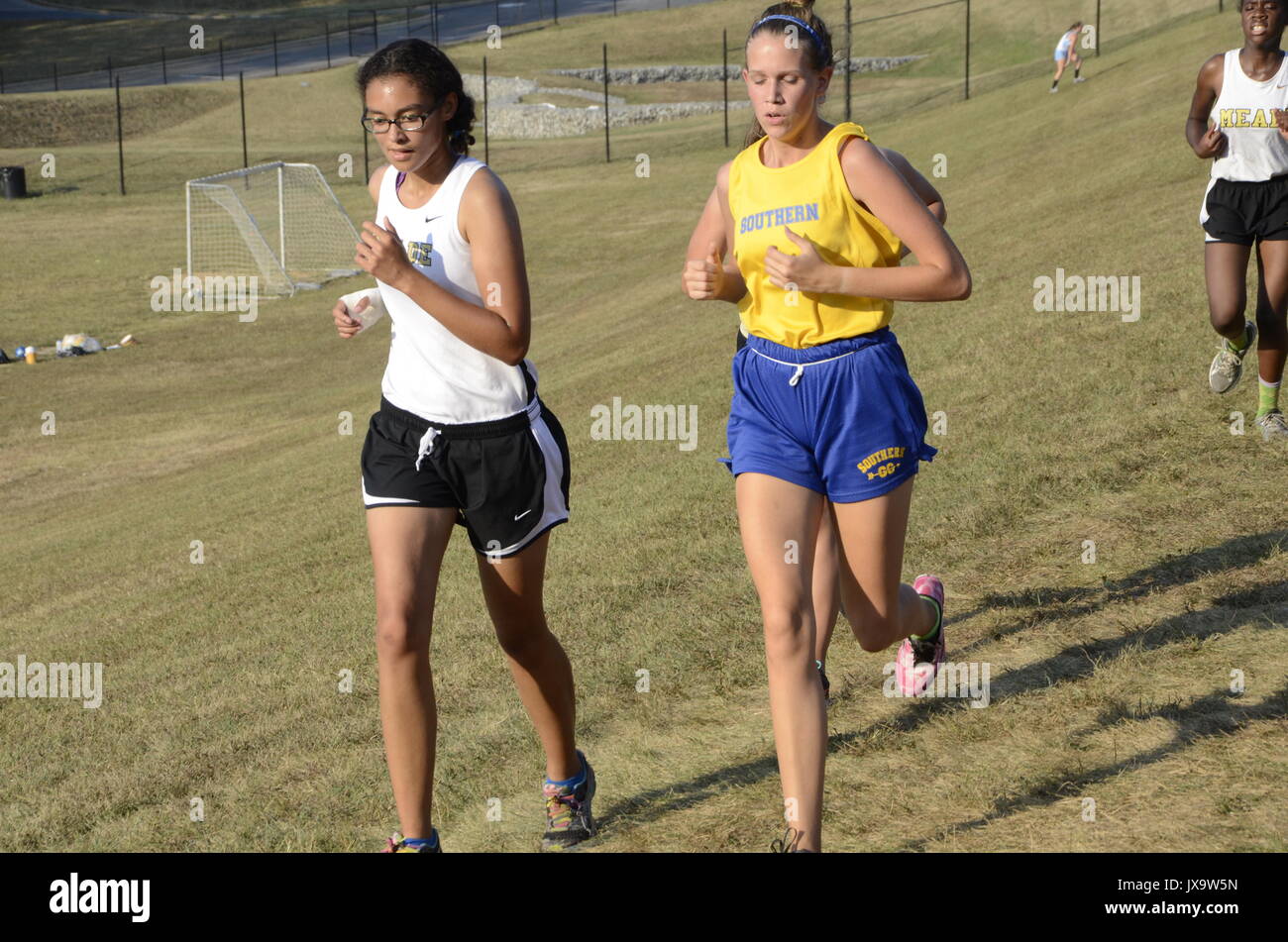 Girls running in a cross country match Stock Photo - Alamy