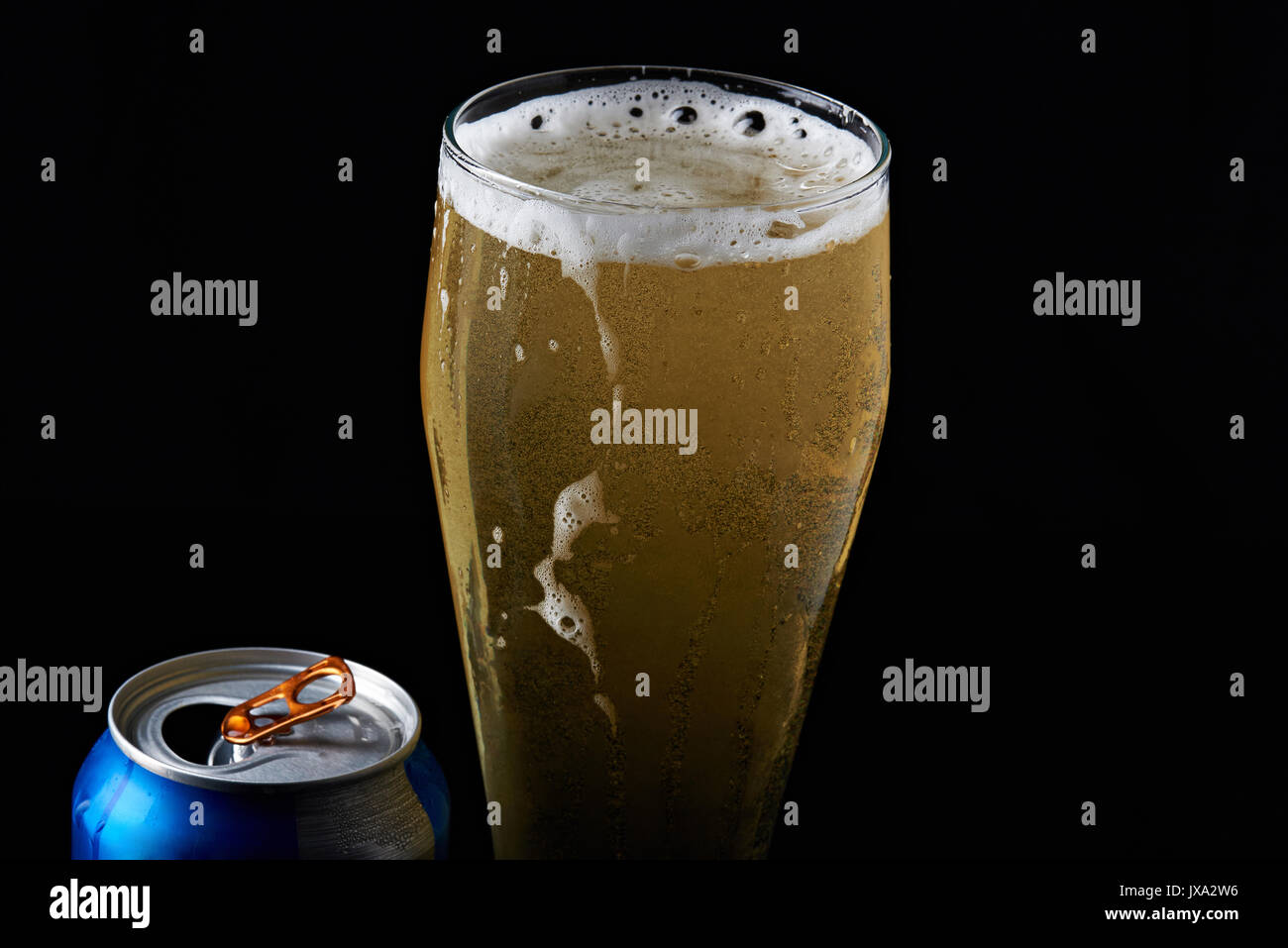 Cold beer in glass from metal can isolated on black background Stock ...