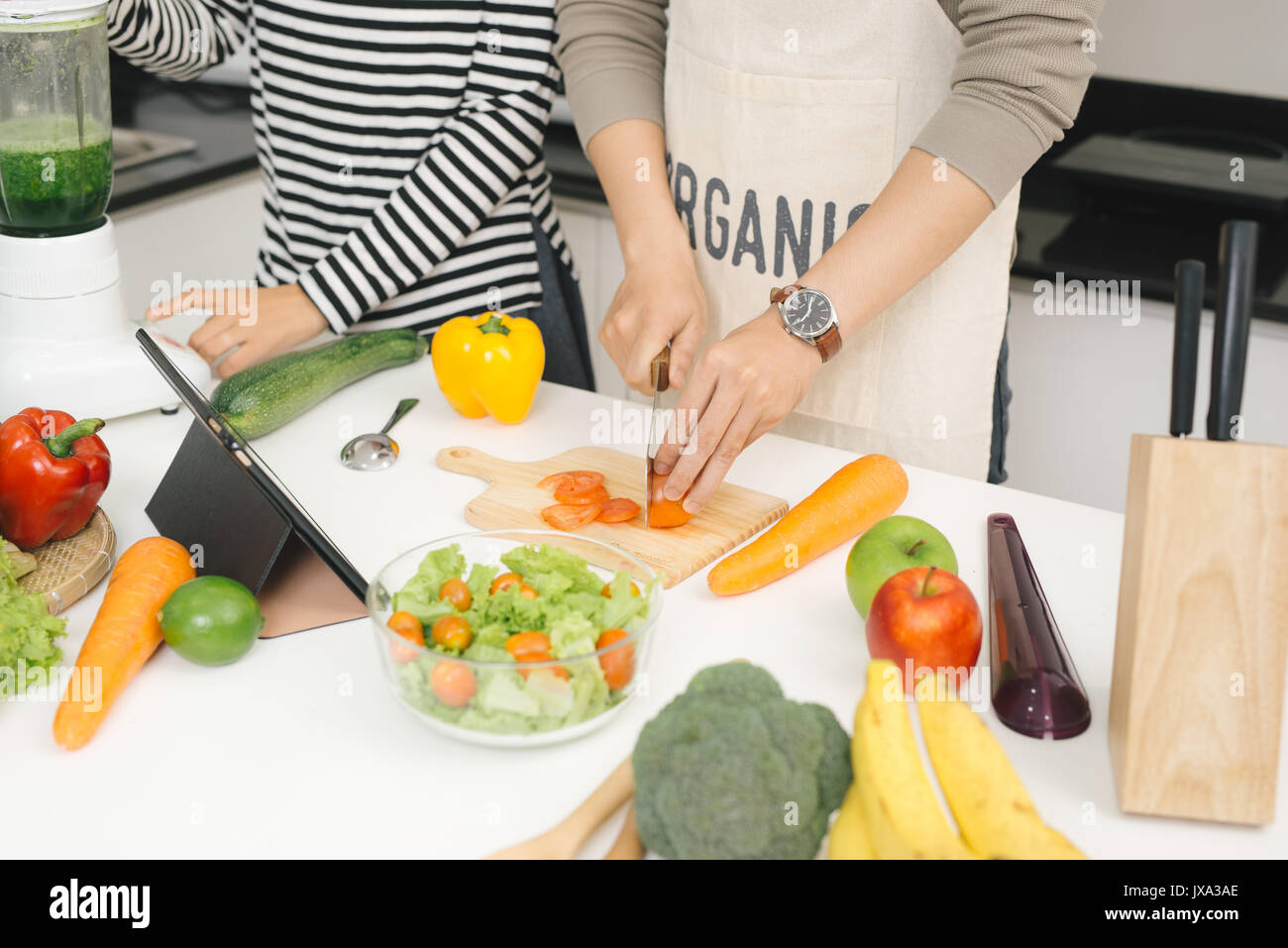 Cooking on family kitchen. Young and beautiful loving couple cooking ...