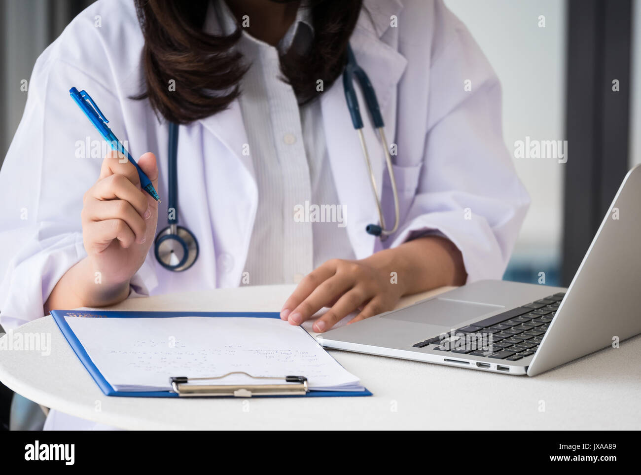 Hand of doctor holding pen are writing a report after treatment ...