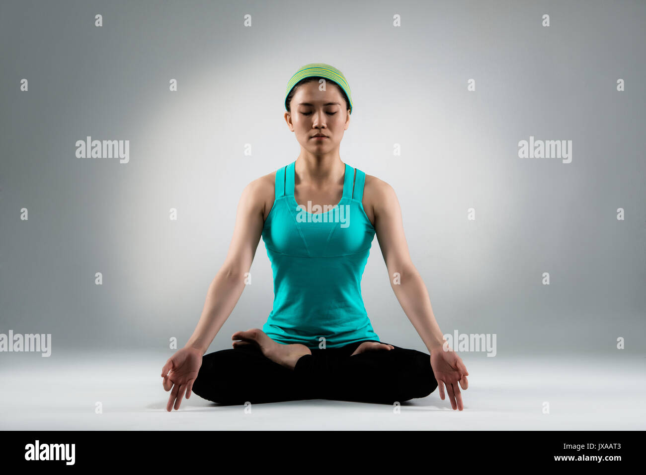 professional yoga coach put zen posture combine fitness sitting on gray ...