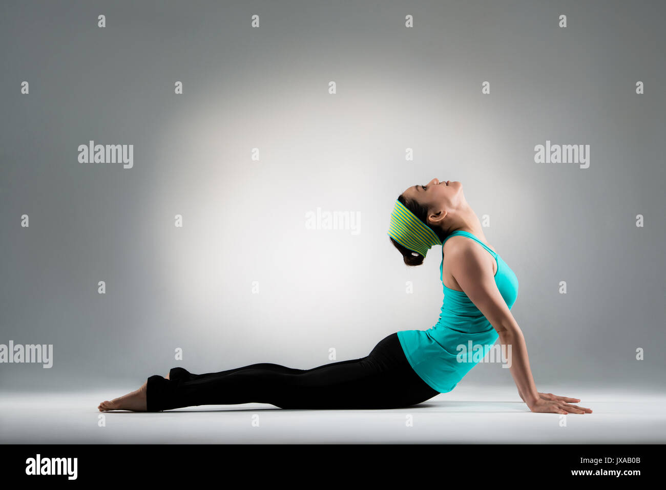 pretty bodybuilding girl head stretches upward and look at wall above ...