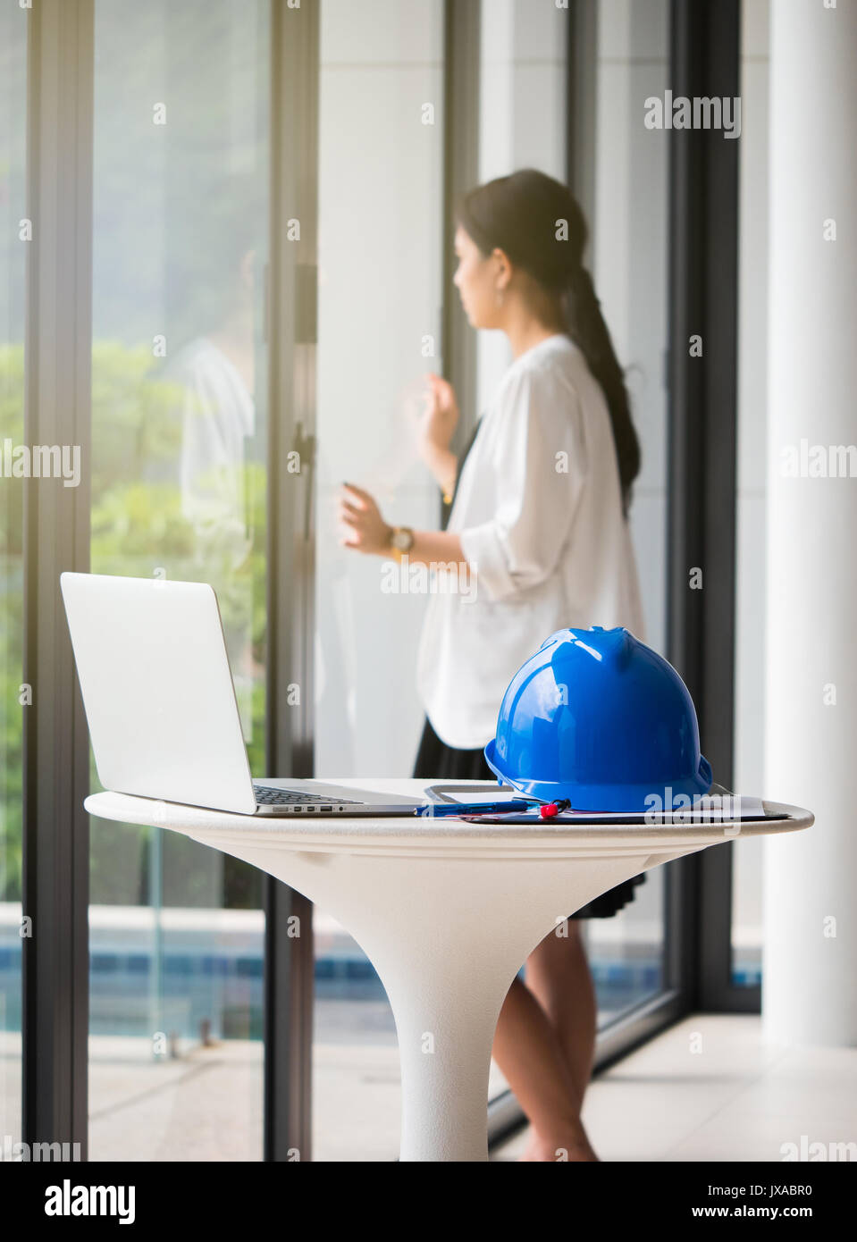 Engineer hats, laptops and a tool used in the design on the table with ...