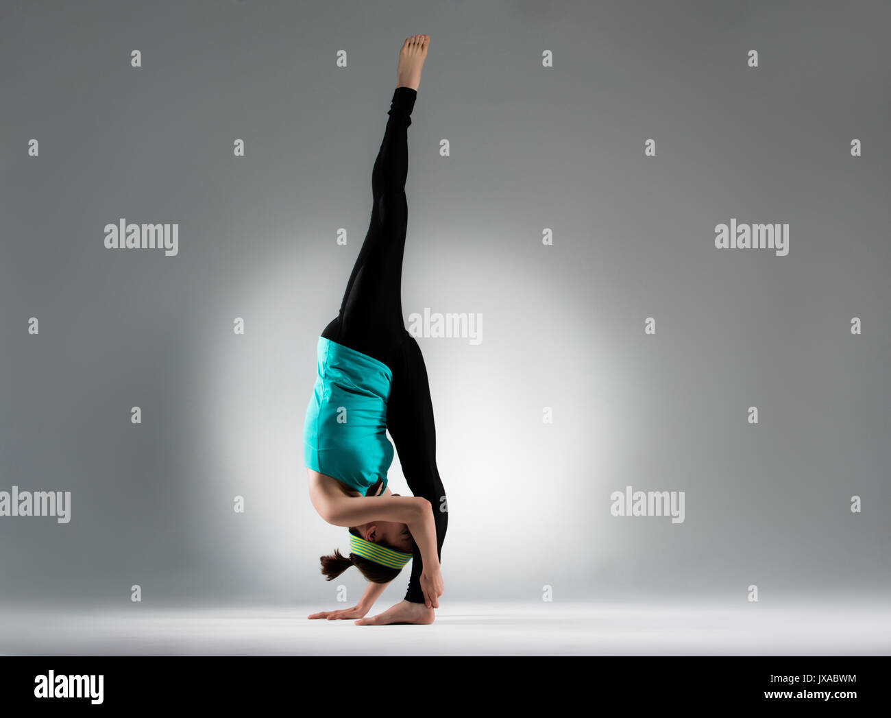 elegant bodybuilding woman single feet standing on gray background ...