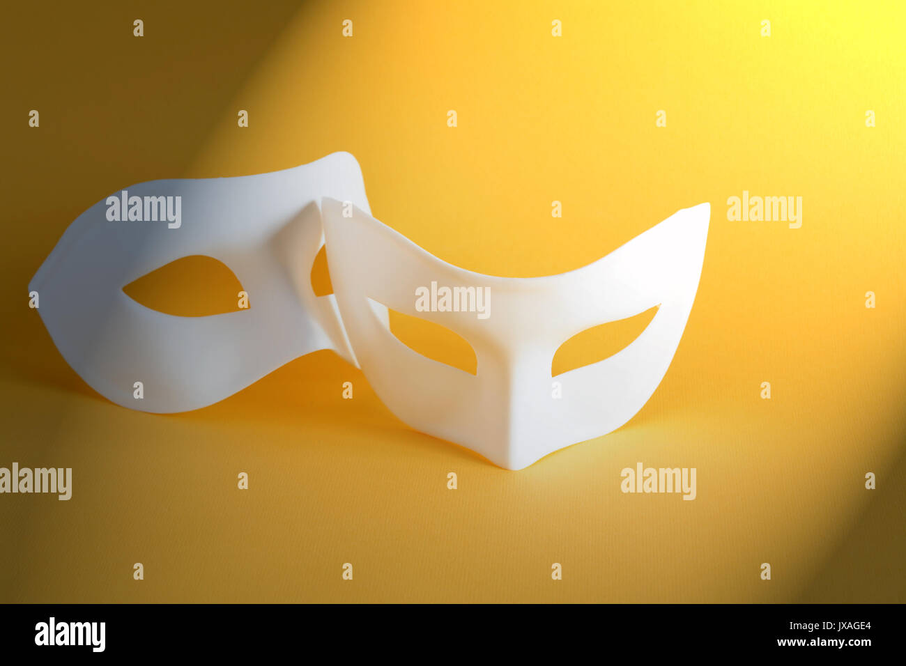 Theater concept. Two white venetian masks on yellow background Stock ...