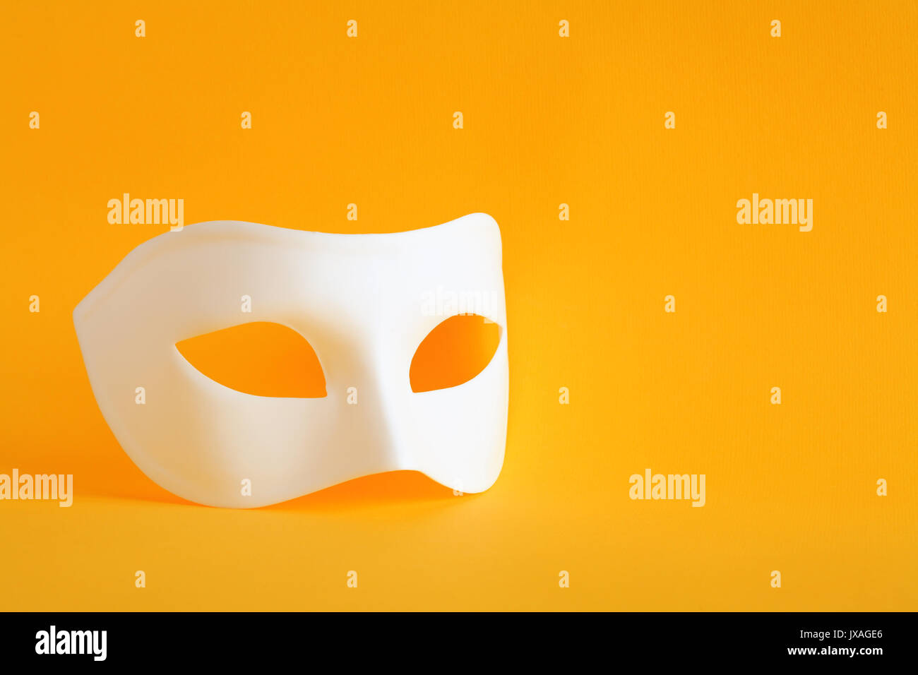 Theater concept. One white venetian mask on yellow background Stock ...