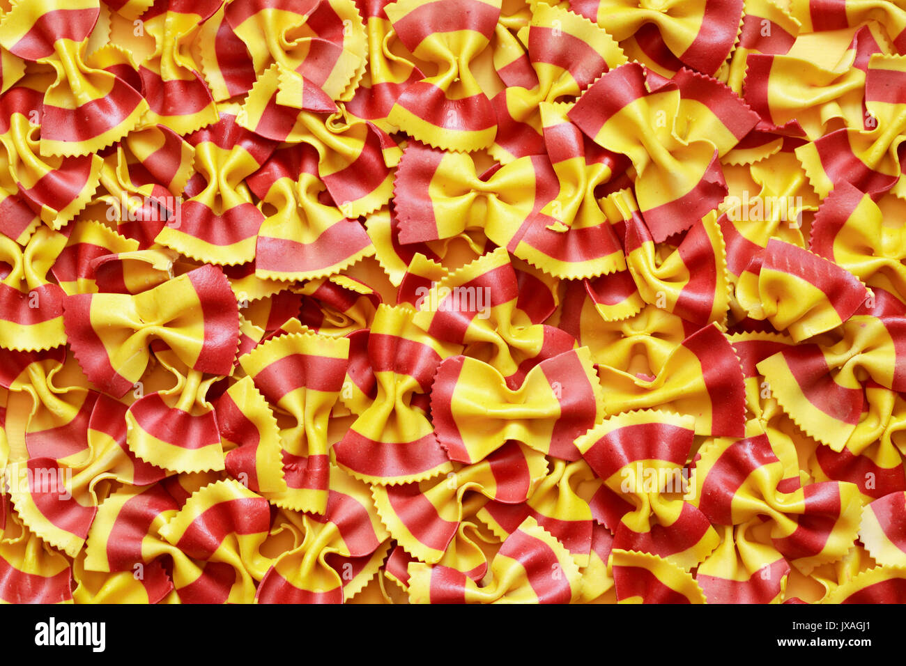 Background made from raw colorful bow tie pasta Stock Photo - Alamy