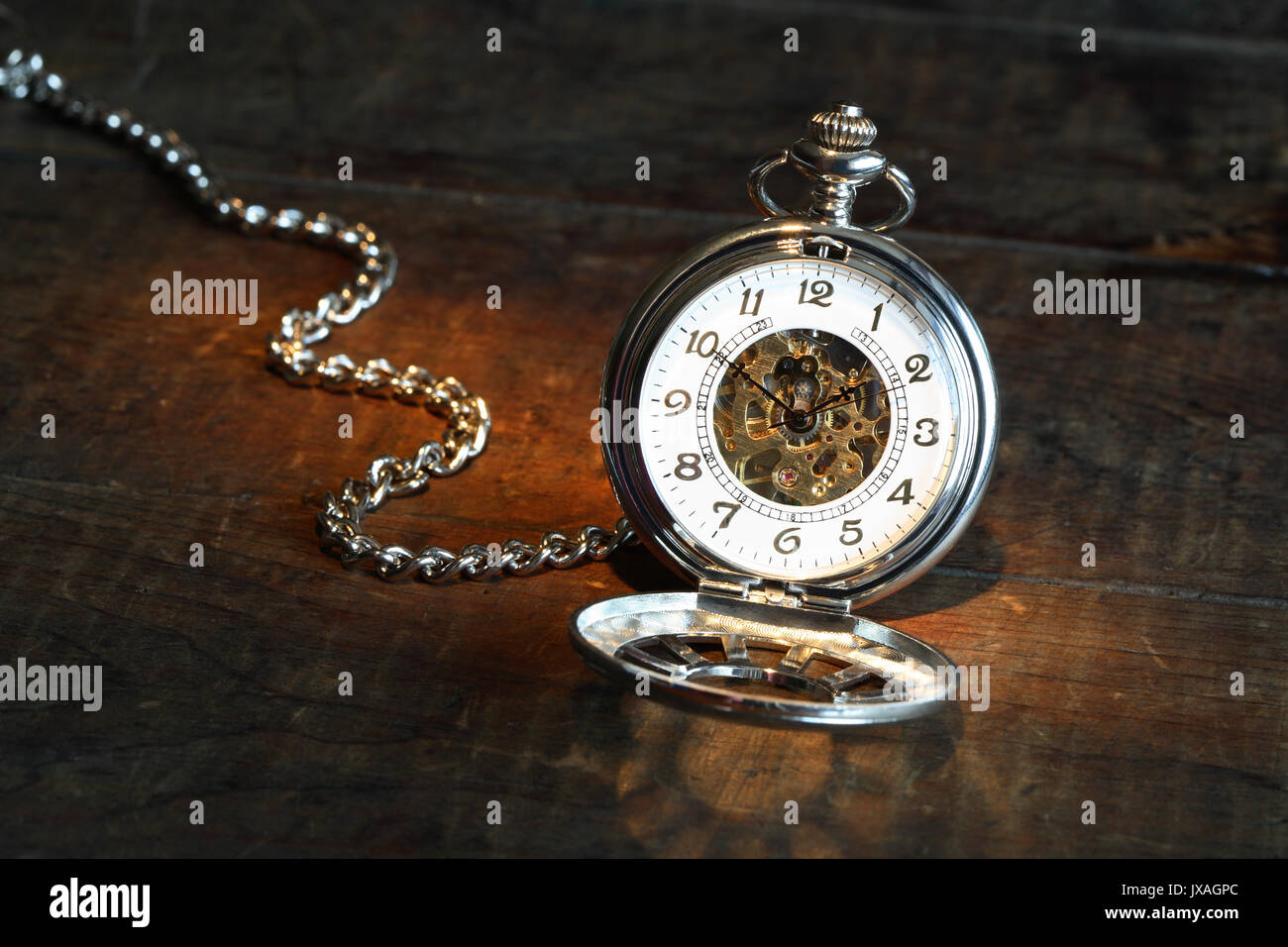 Vintage pocket watch with open lid and chain on wooden surface Stock ...